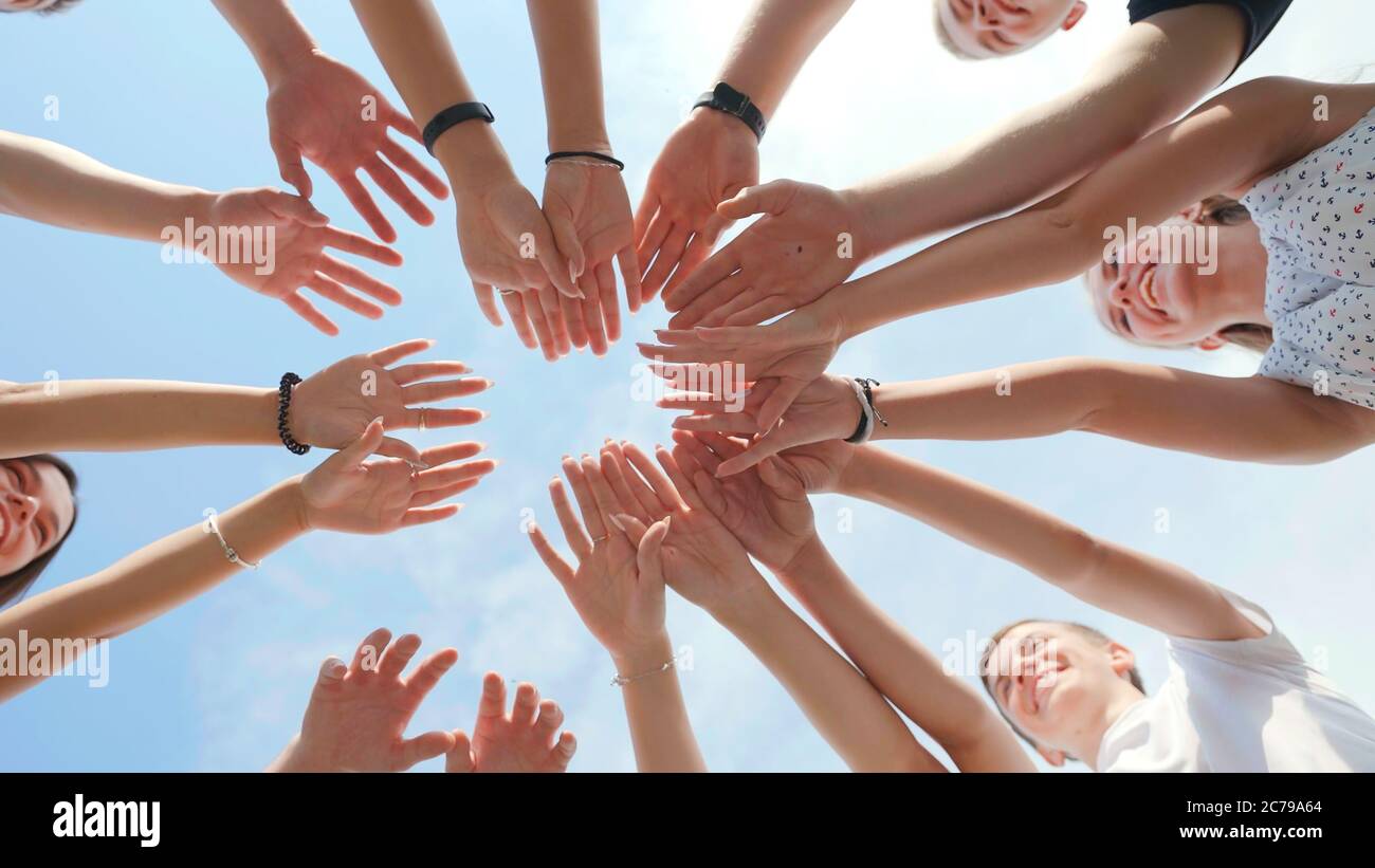 Friendly friends clasp hands as a sign of strong friendship and ...
