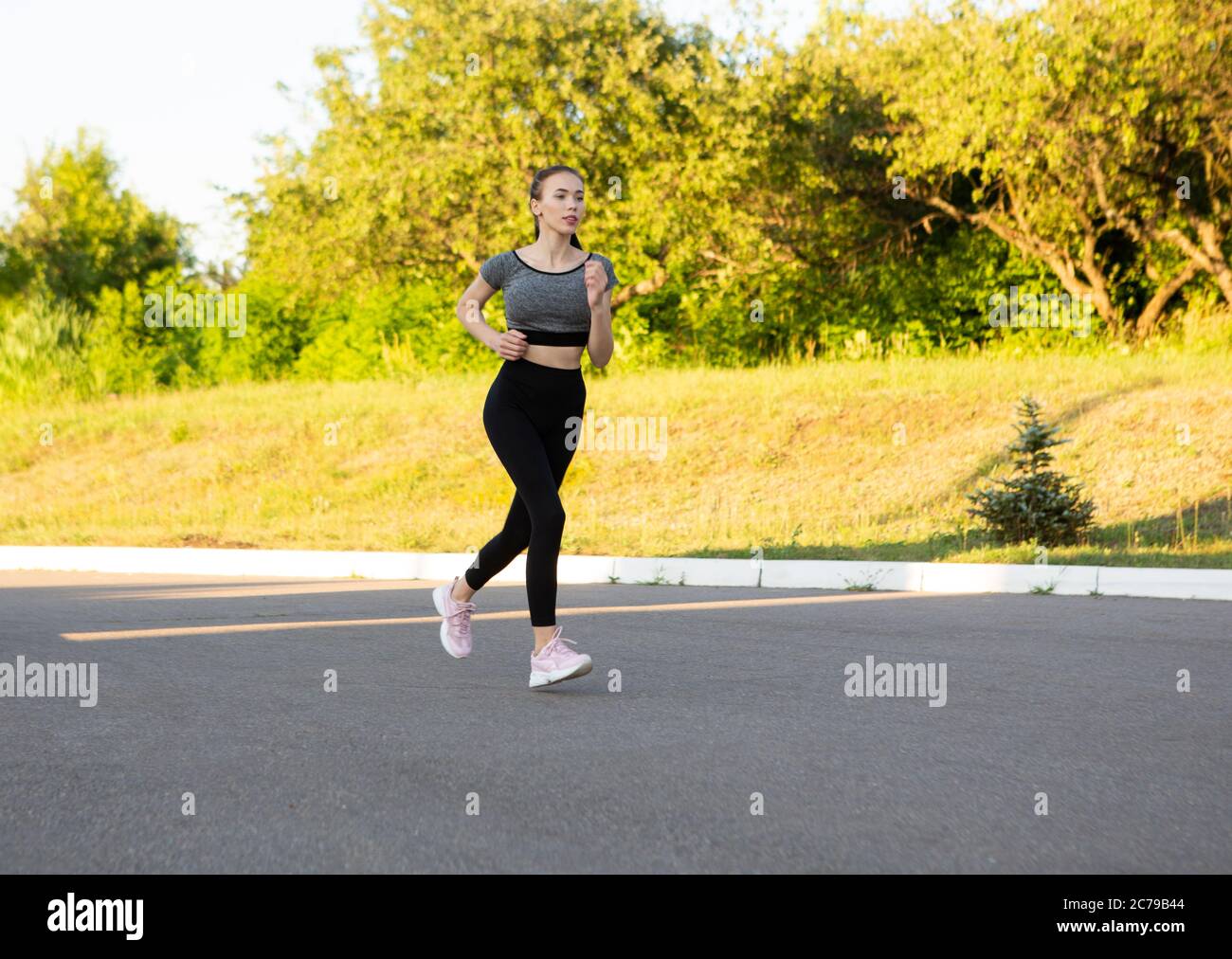 Side view of active sporty young running woman runner Stock Photo - Alamy