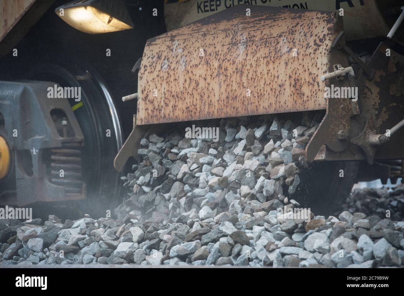 Network Rail train laying new ballast on track on a stretch of railway ...