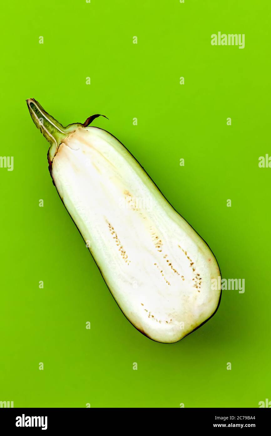 One half of eggplant on the light green background. Fresh vegetables ...