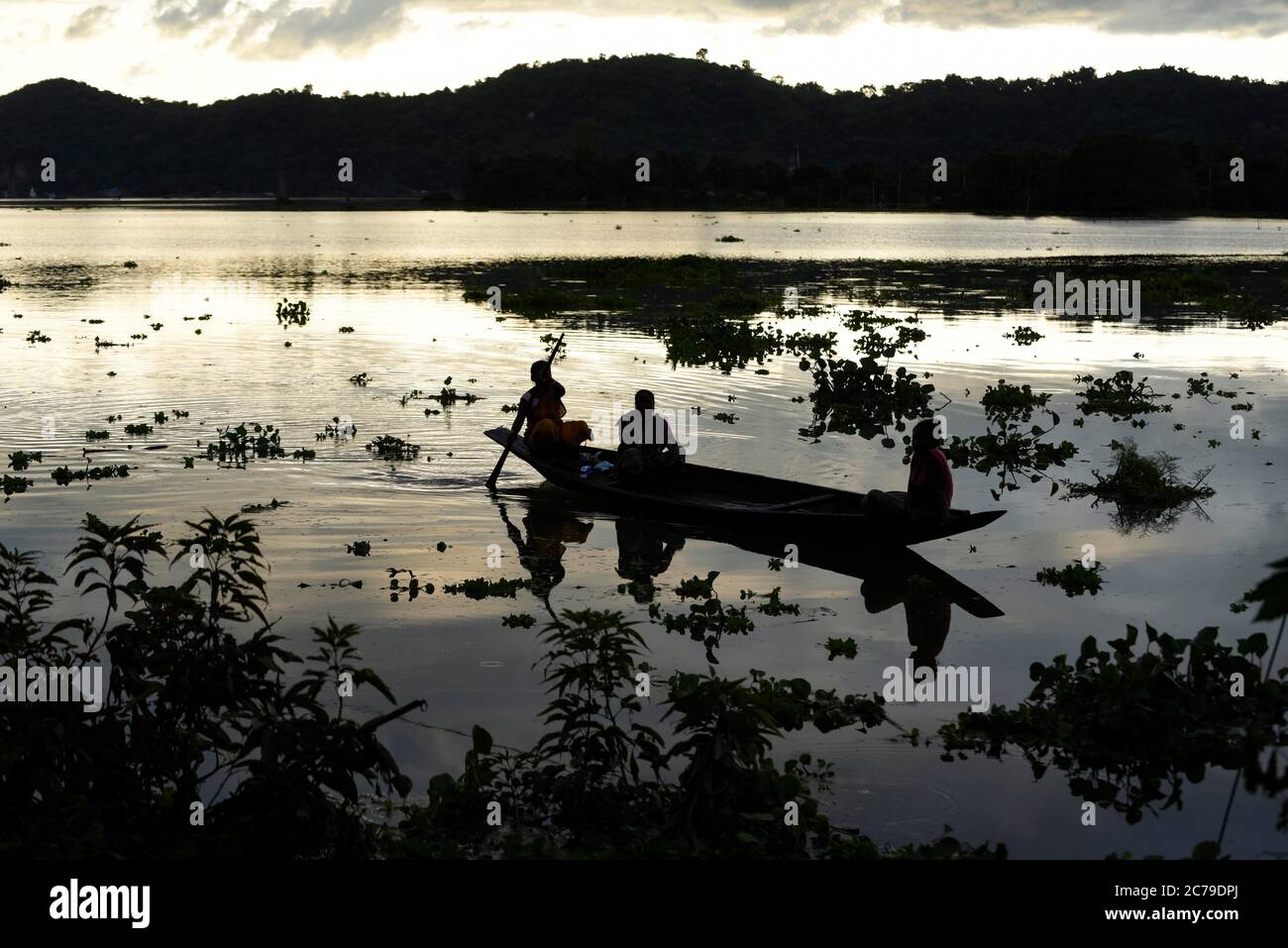 Kamrup, Assam, India. 15th July, 2020. Villager uses a country boat to ...