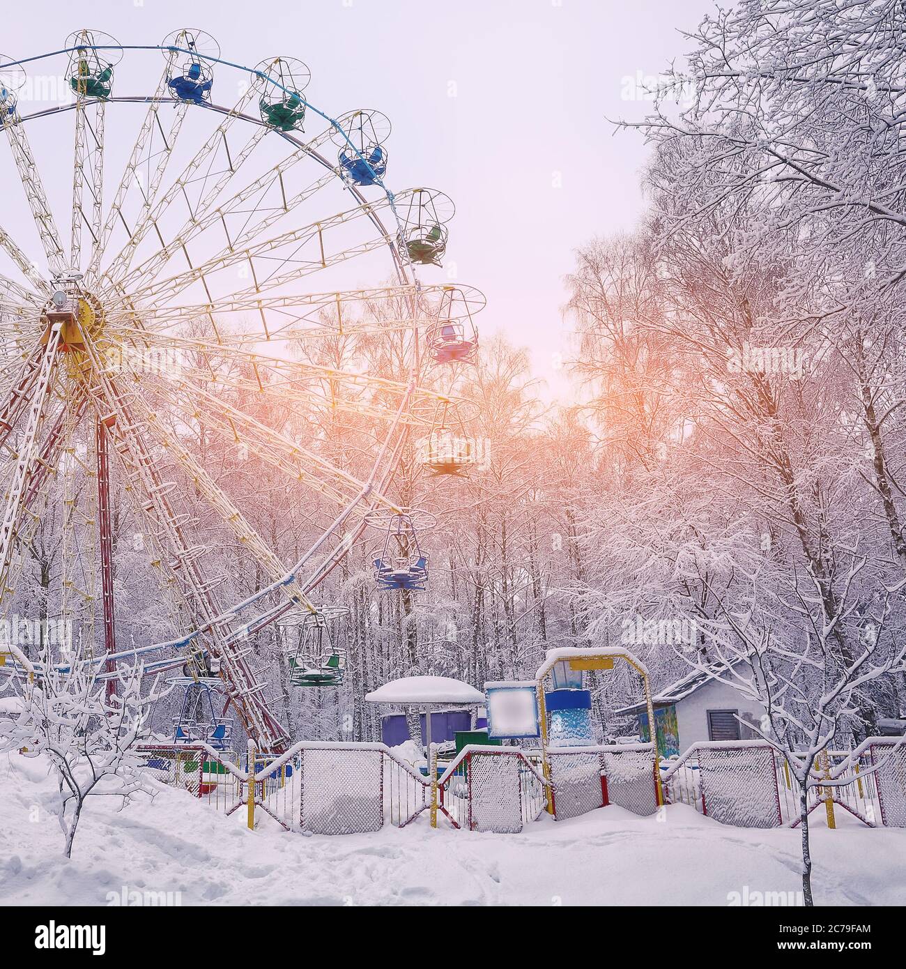 Snow covered Ferris wheel surrounded by snowcovered trees. Lots of snow ...