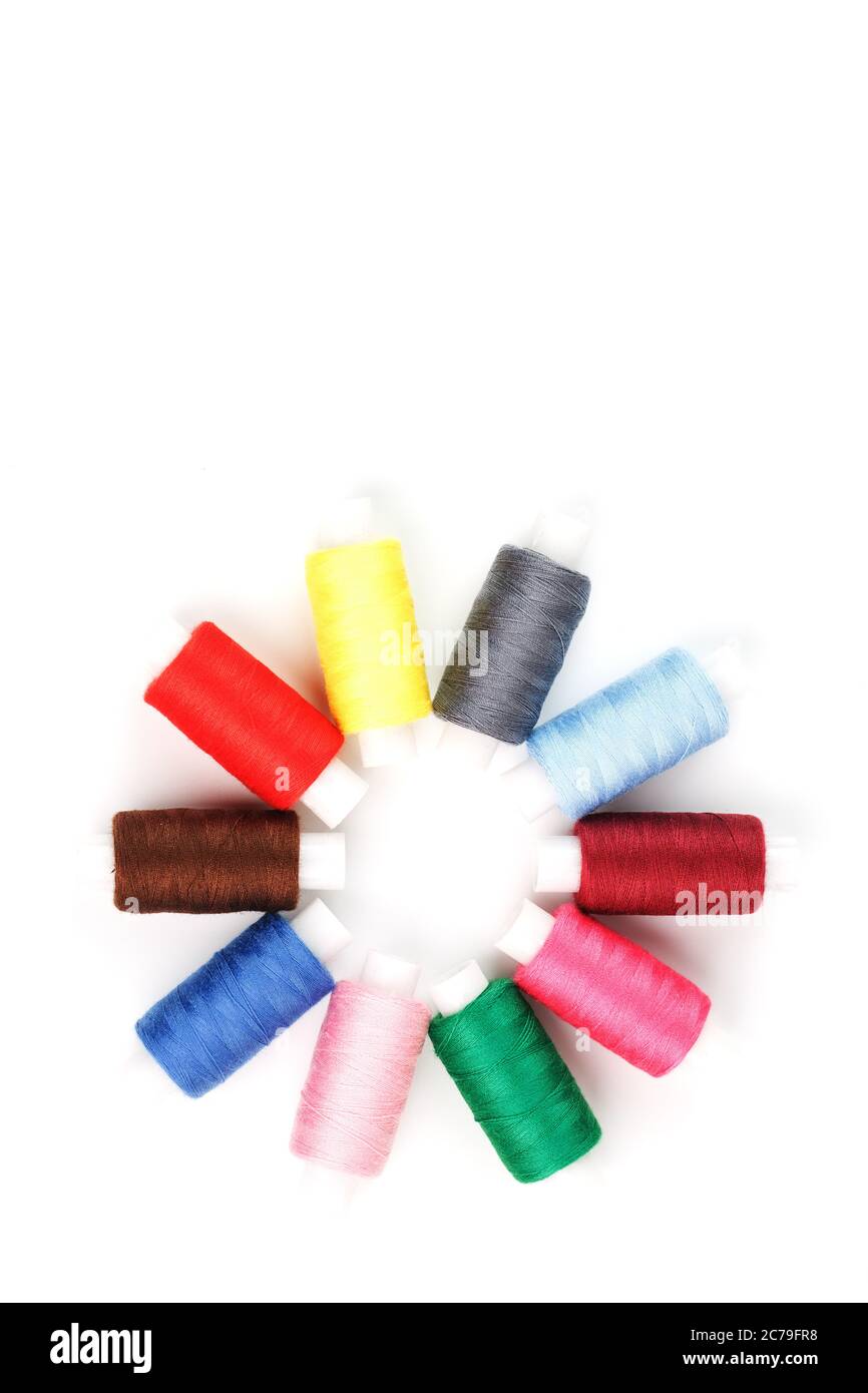 Colorful cotton craft sewing threads in flower shape isolated on white ...