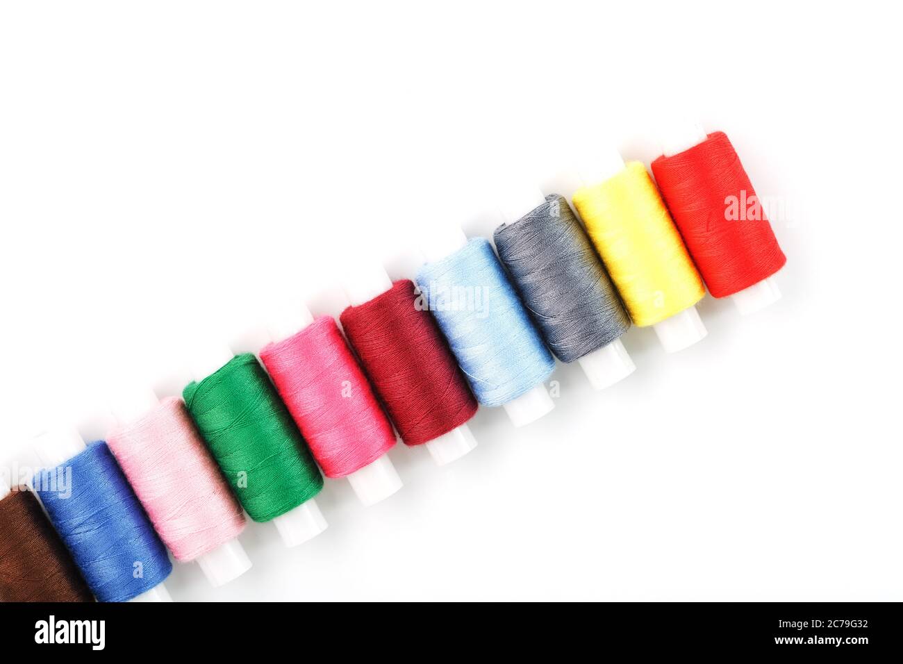 Colorful cotton craft sewing threads multicolored in a row isolated on ...