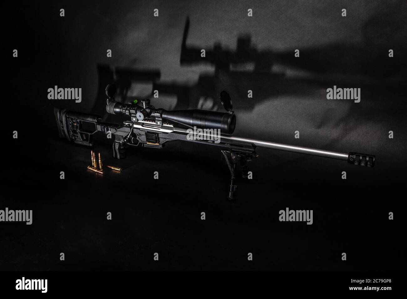 Modern black sniper rifle with optical sight on a dark background. Bolt ...