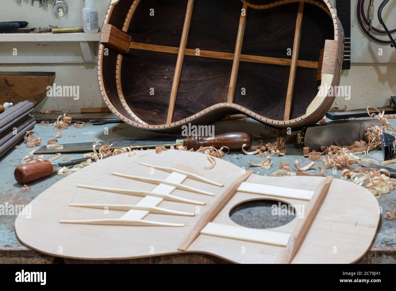 Luthier workbench with tools and an acoustic guitar under construction ...