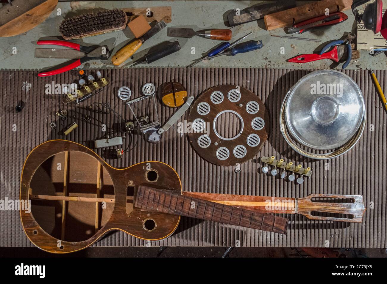 Luthier workbench with tools and a resonator guitar Stock Photo - Alamy