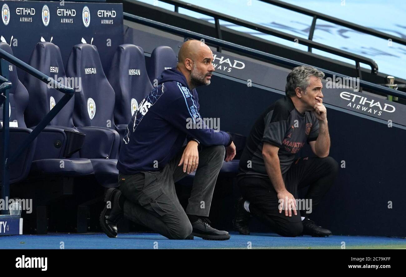 Manchester City manager Pep Guardiola takes a knee in support of the ...