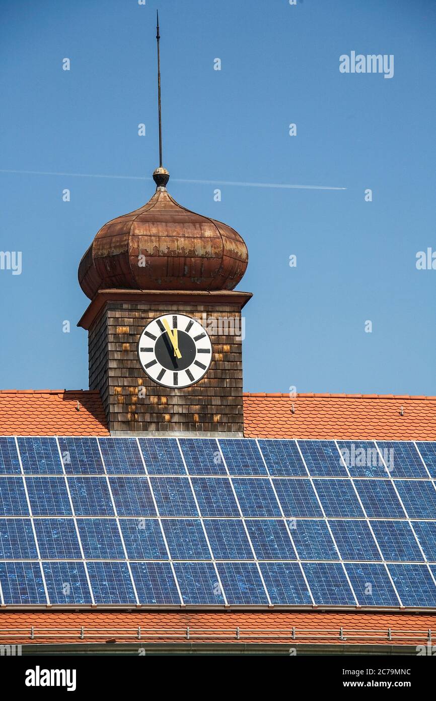 Solar panels on roof with clock-tower showing 5 to 12 Stock Photo - Alamy