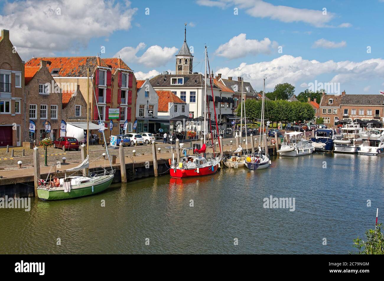 harbor scene, boats docked, sailboats, motor yachts, old town buildings ...