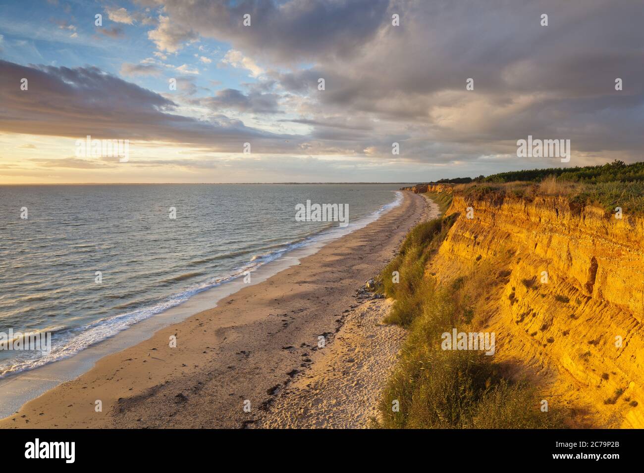 Empty beach at Penestin with sandstone cliff in the evening. This cliff ...