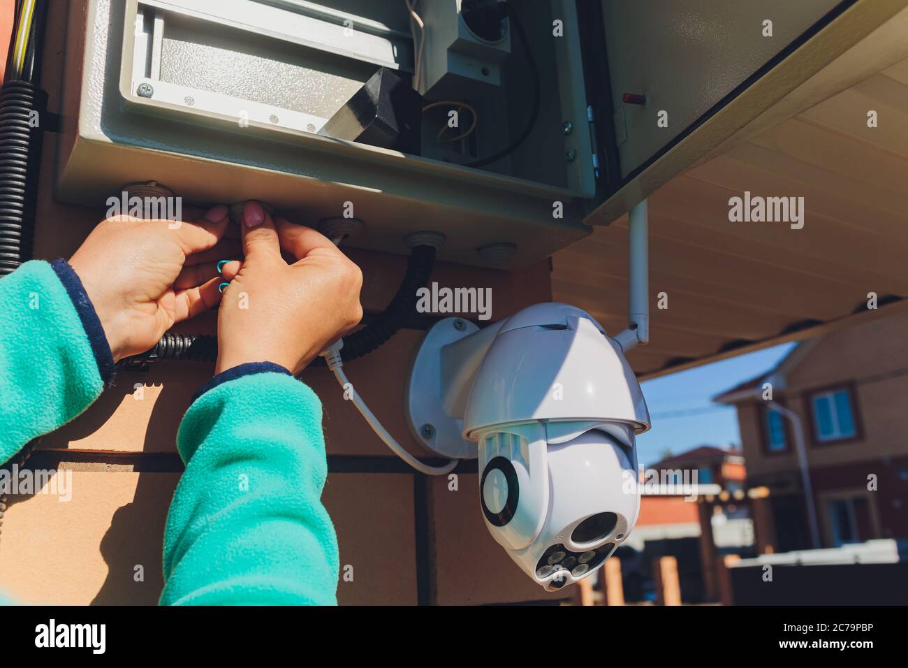 technician female setup cctv camera on wall Stock Photo - Alamy