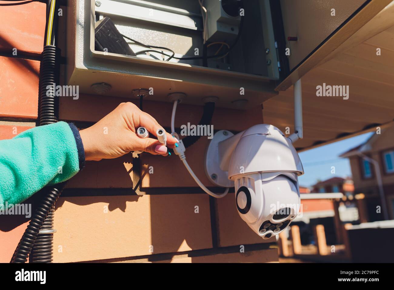 technician female setup cctv camera on wall Stock Photo - Alamy