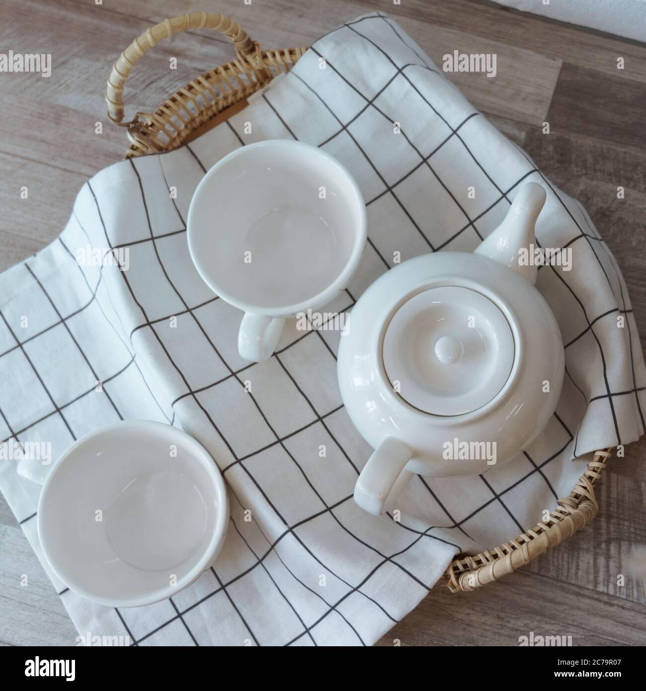 Flat lay of white tea pot and cups on rattan tray on wood Stock Photo ...