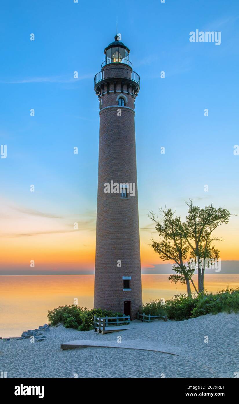 View of Little Sable Point Lighthouse at sunset overlooking Lake ...