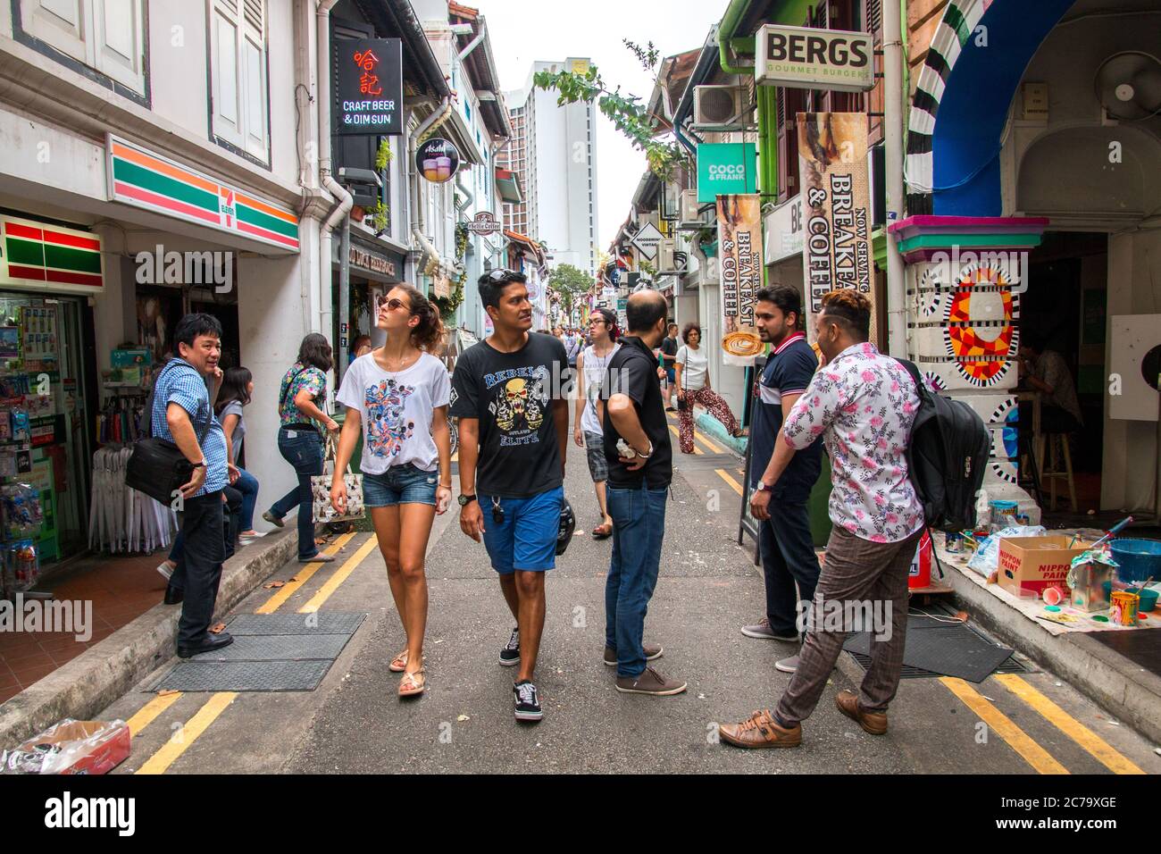 tourists walking in the famous colourful streets of Sultan Mosque ...