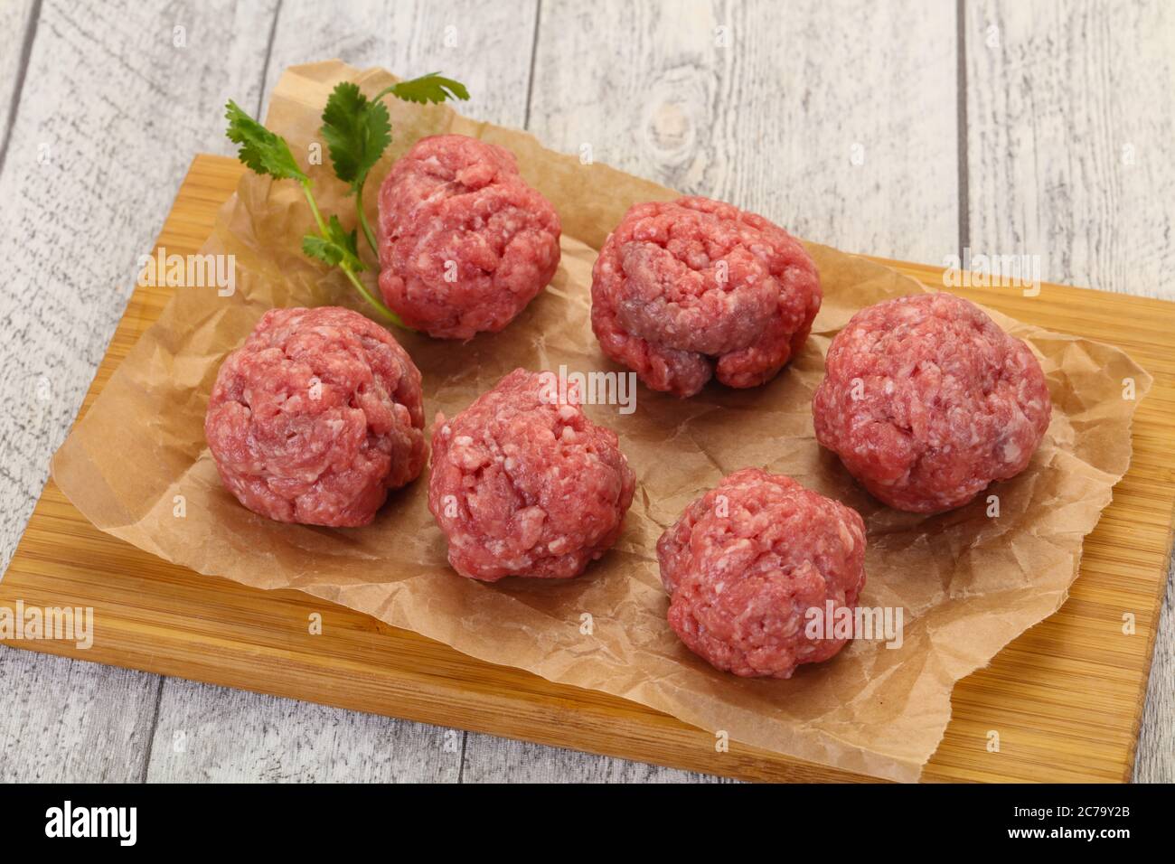Raw meatball over wooden background ready for cooking Stock Photo - Alamy