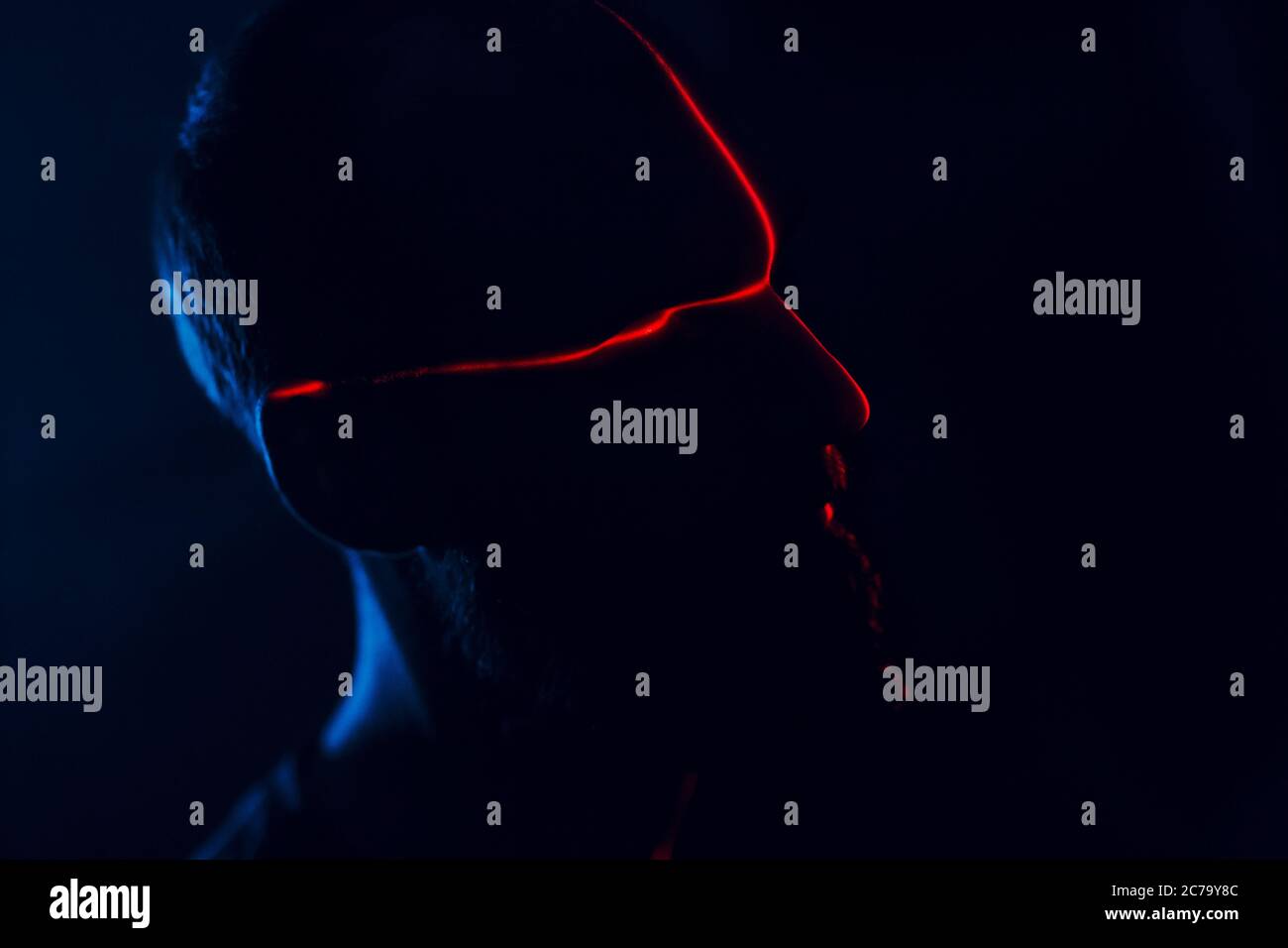 Man in dark with face illuminated by scan red laser on contour Stock ...
