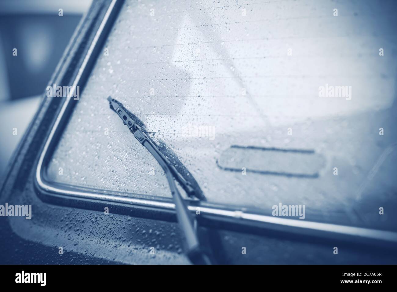 The rear window of the car and the windshield wiper are covered with ...