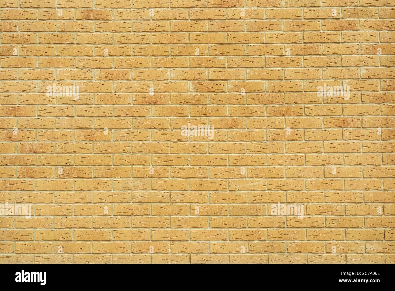 yellow brick wall background. masonry consists of notched bricks ...