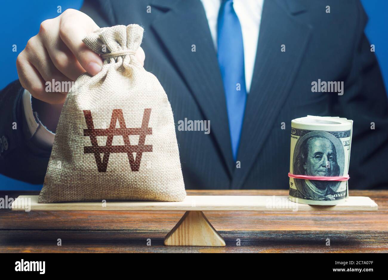 A man puts south korean won money bag on the scales opposite to the ...
