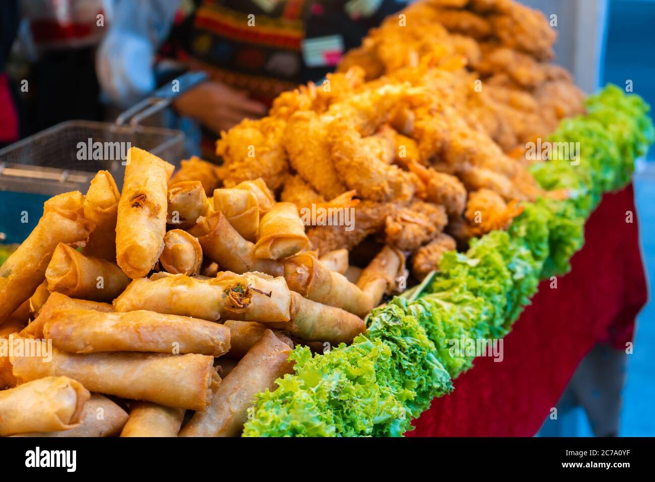 Street food market in Asia. Food counters, mini barbecue on a stick ...