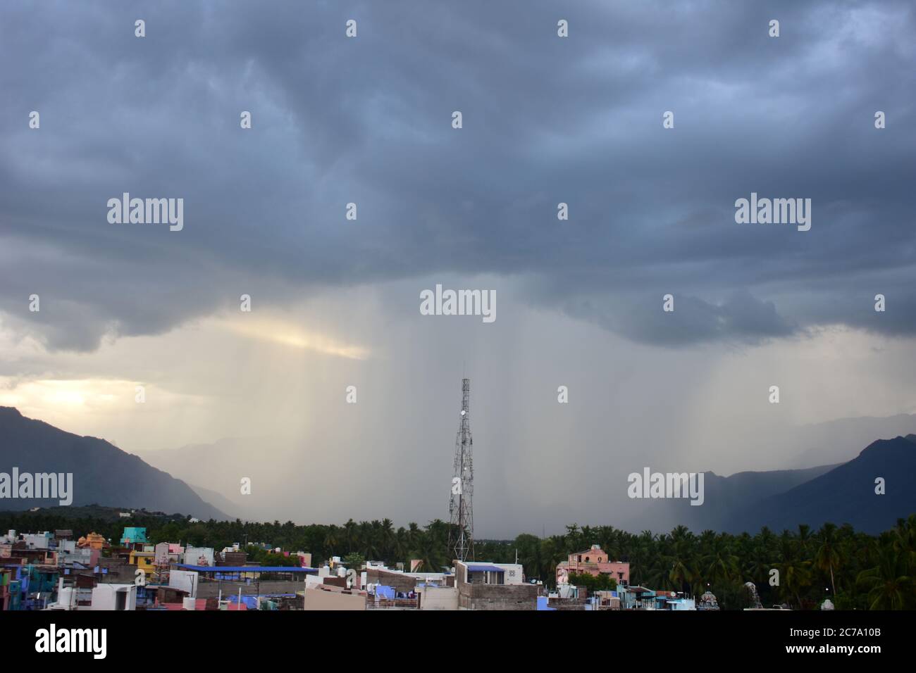Rain shower falling from dark cumulus clouds Stock Photo - Alamy