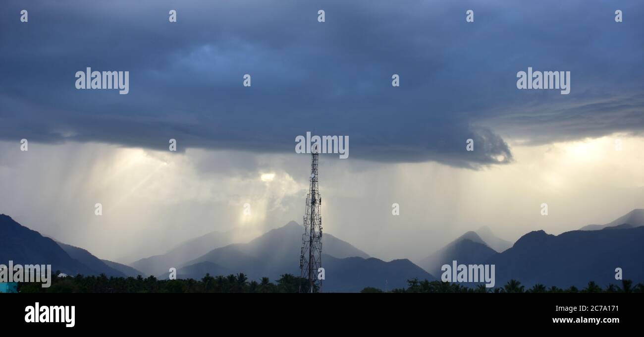 Rain shower falling from dark cumulus clouds Stock Photo - Alamy