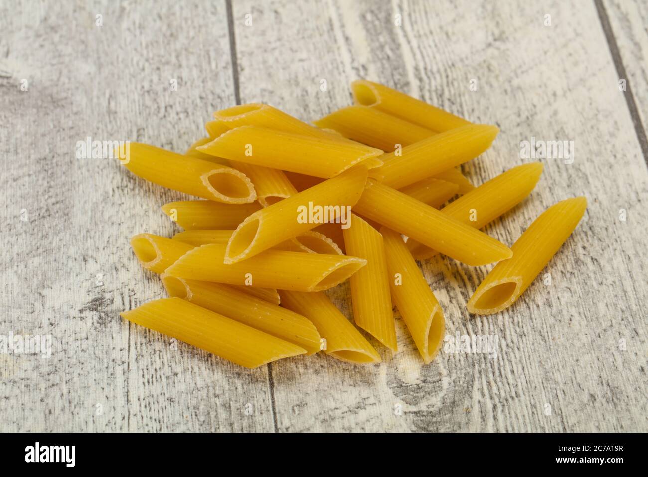 Raw penne pasta ready for bowl Stock Photo - Alamy