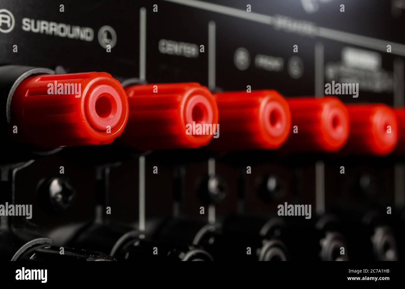 View on isolated red speaker outputs in a row of back side of black ...