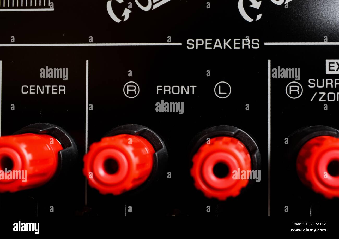 View on isolated red speaker outputs in a row of back side of black ...