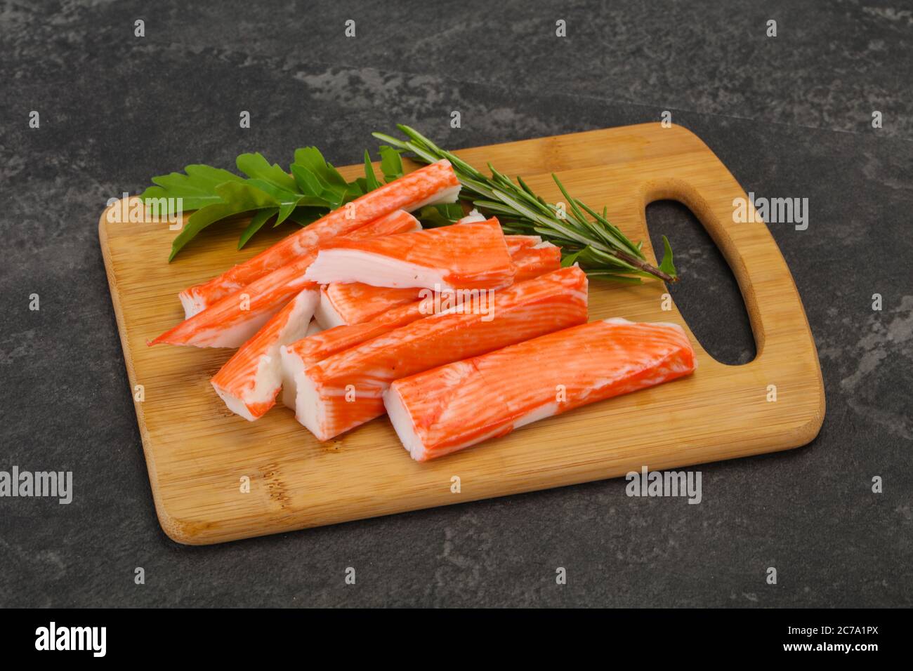 Crab stick surimi over wooden board Stock Photo - Alamy