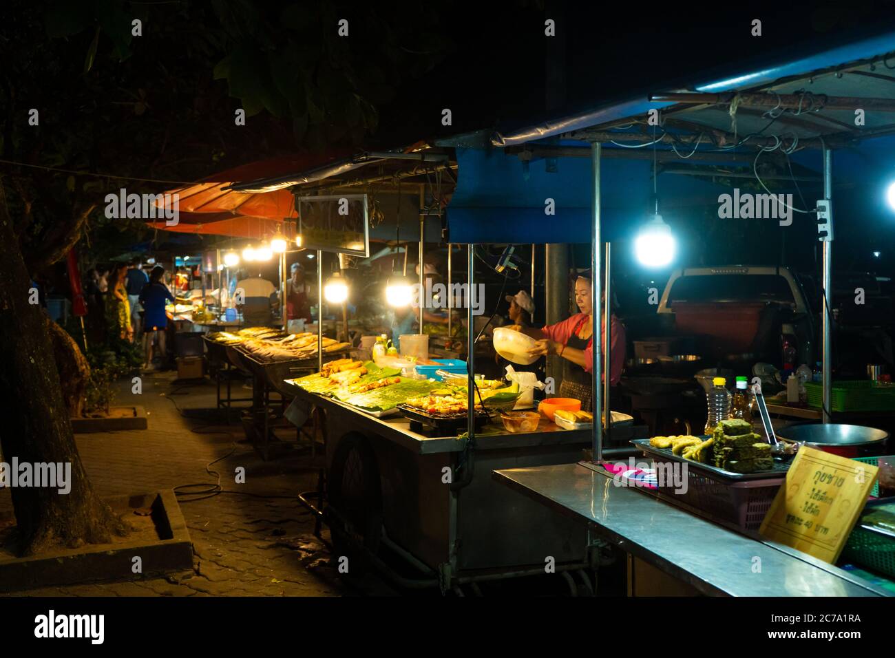 Asian street food night market. Mobile food counter carts Stock Photo ...
