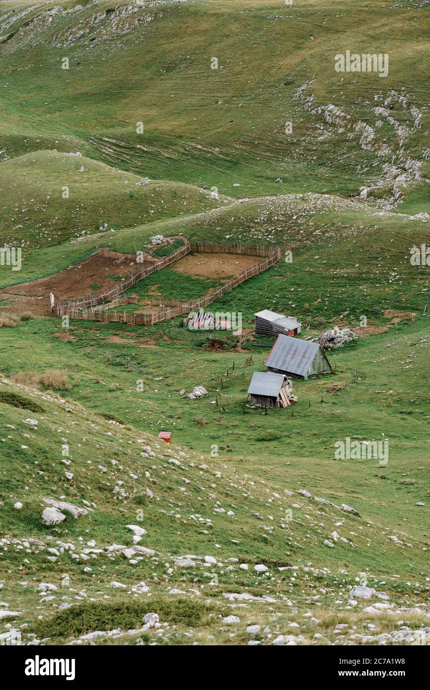 An empty sheepfold in the green hills among the mountains of Montenegro ...