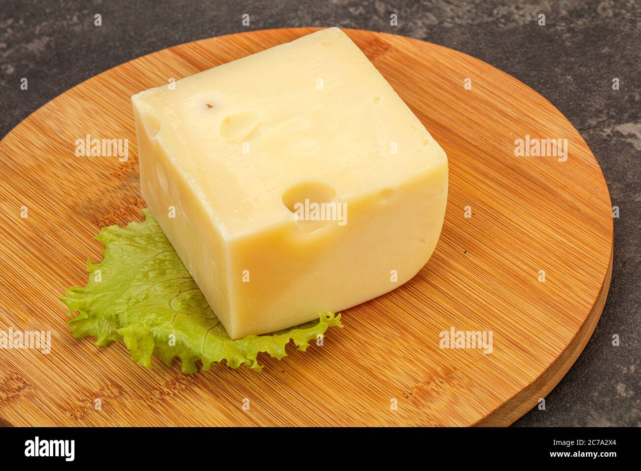 Emmental cheese over wooden board served salad Stock Photo - Alamy