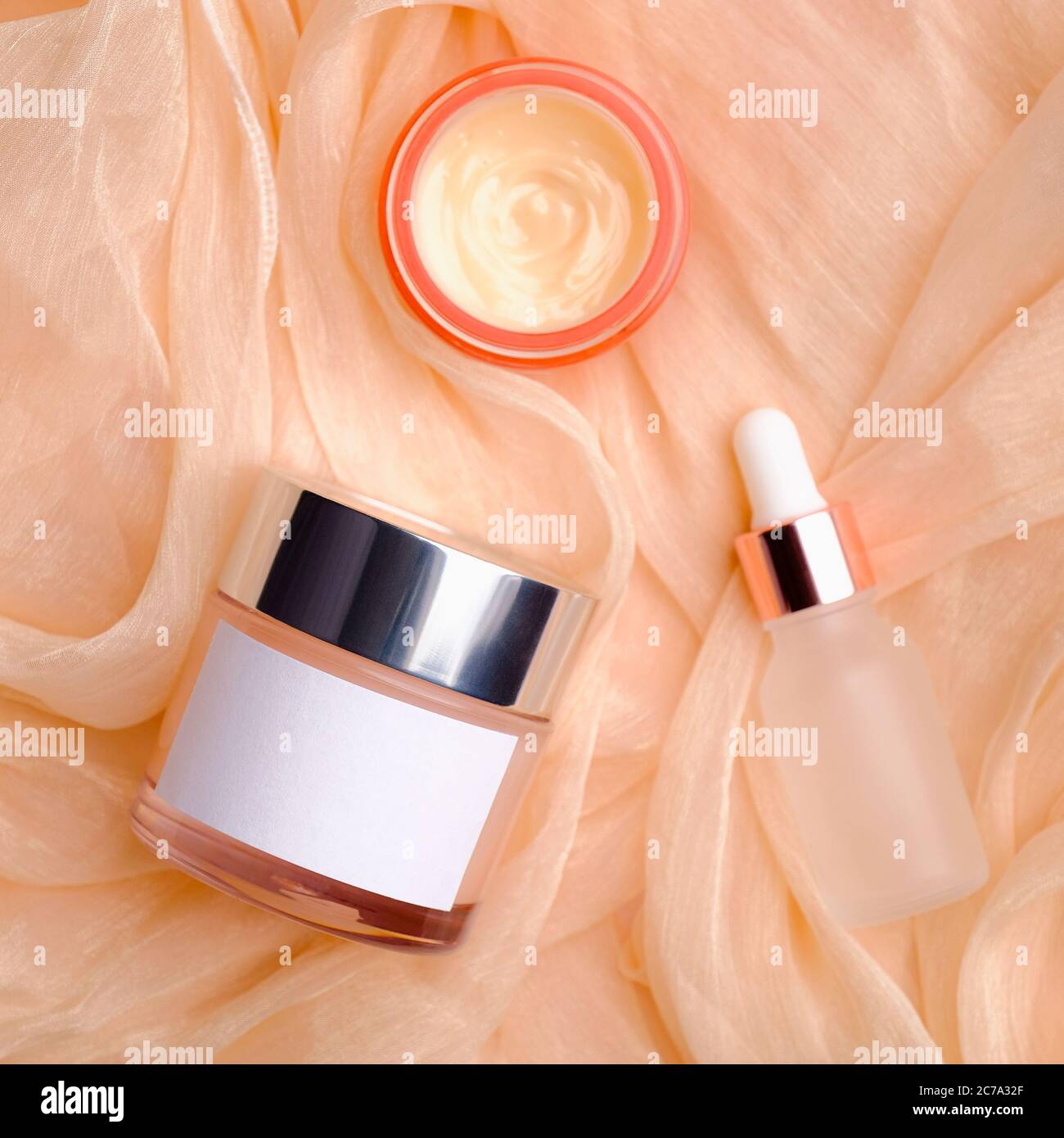 Cosmetics jar with moisturizer cream and body lotion on peach color ...