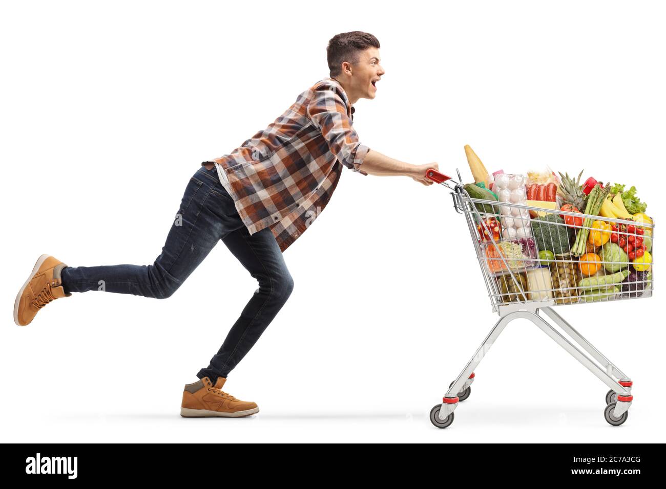 Happy young man running with a full shopping cart isolated on white ...