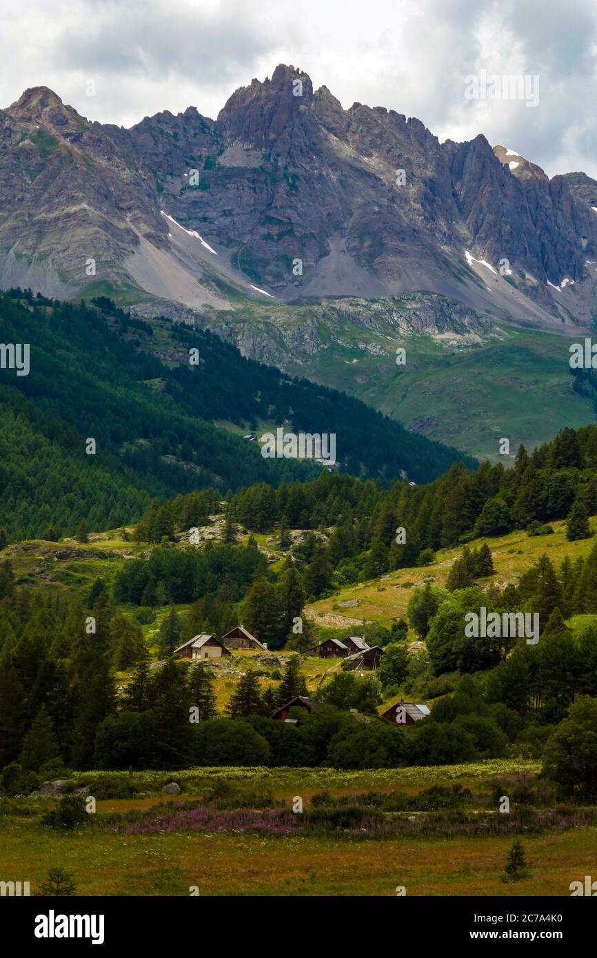 Chalets and mountain peaks in The Haute Vallee de Claree, near Briancon ...