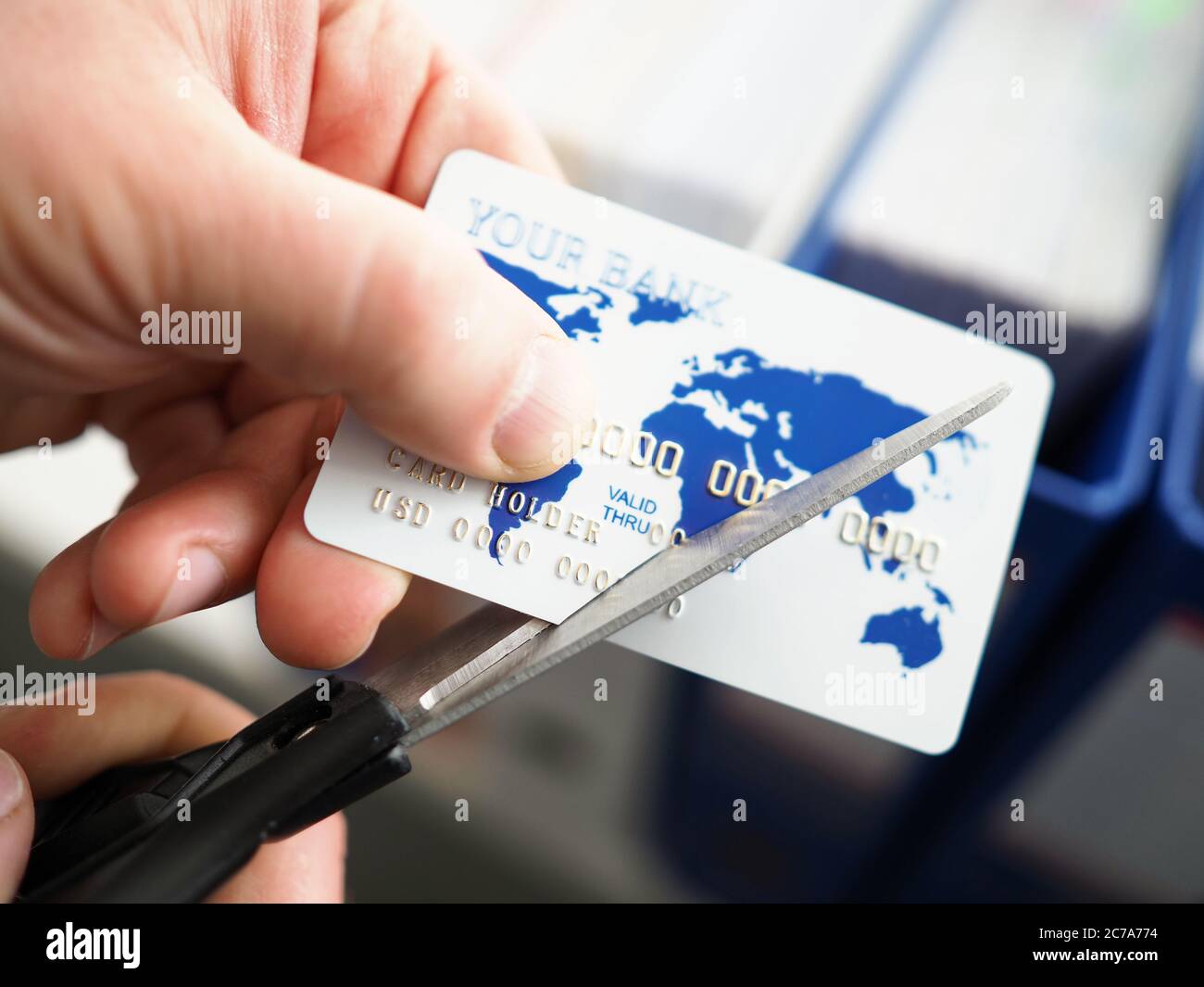 Male hand cutting banking card with scissors Stock Photo - Alamy