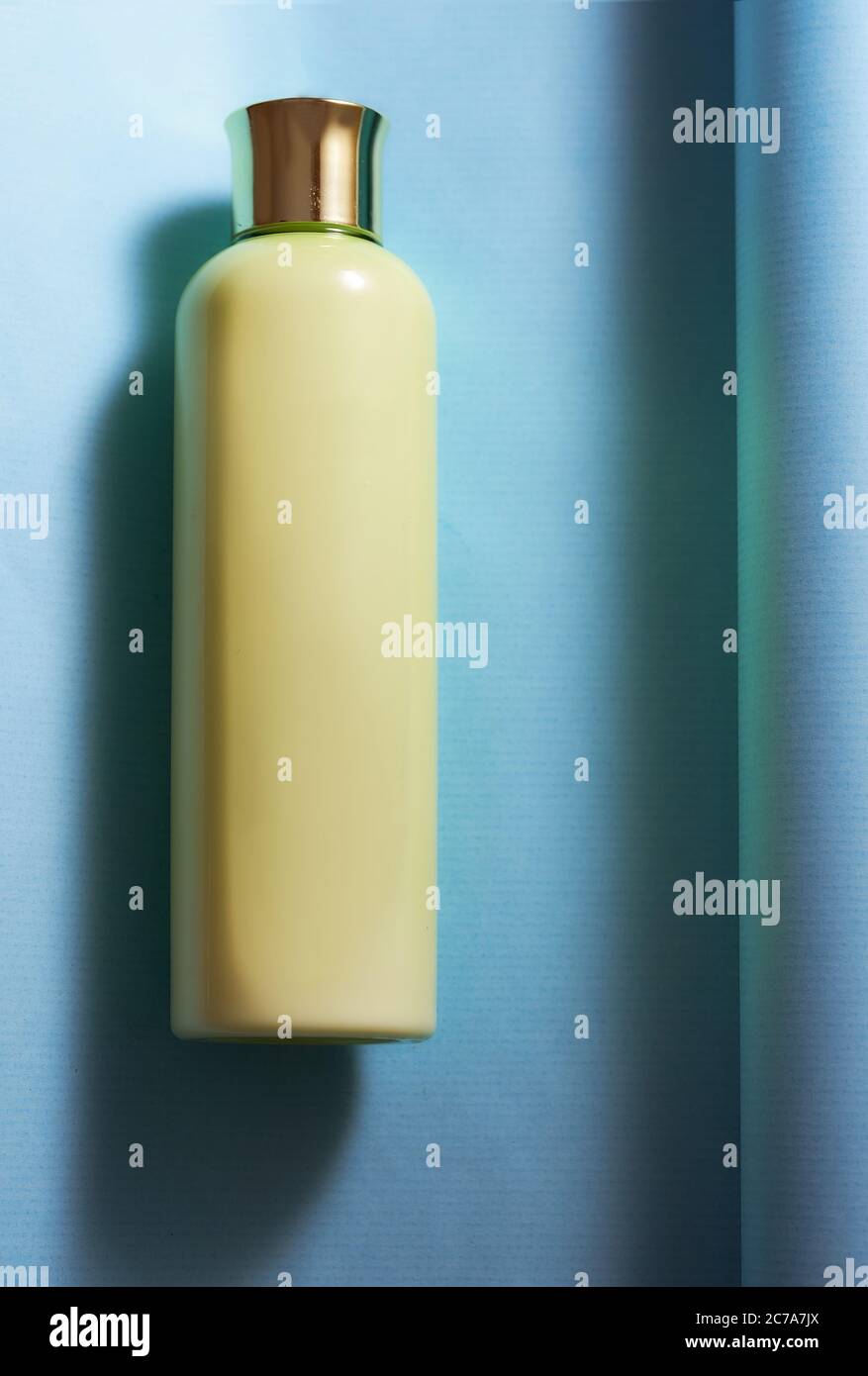 Yellow vial for cosmetics on a blue background. With copy space Stock ...