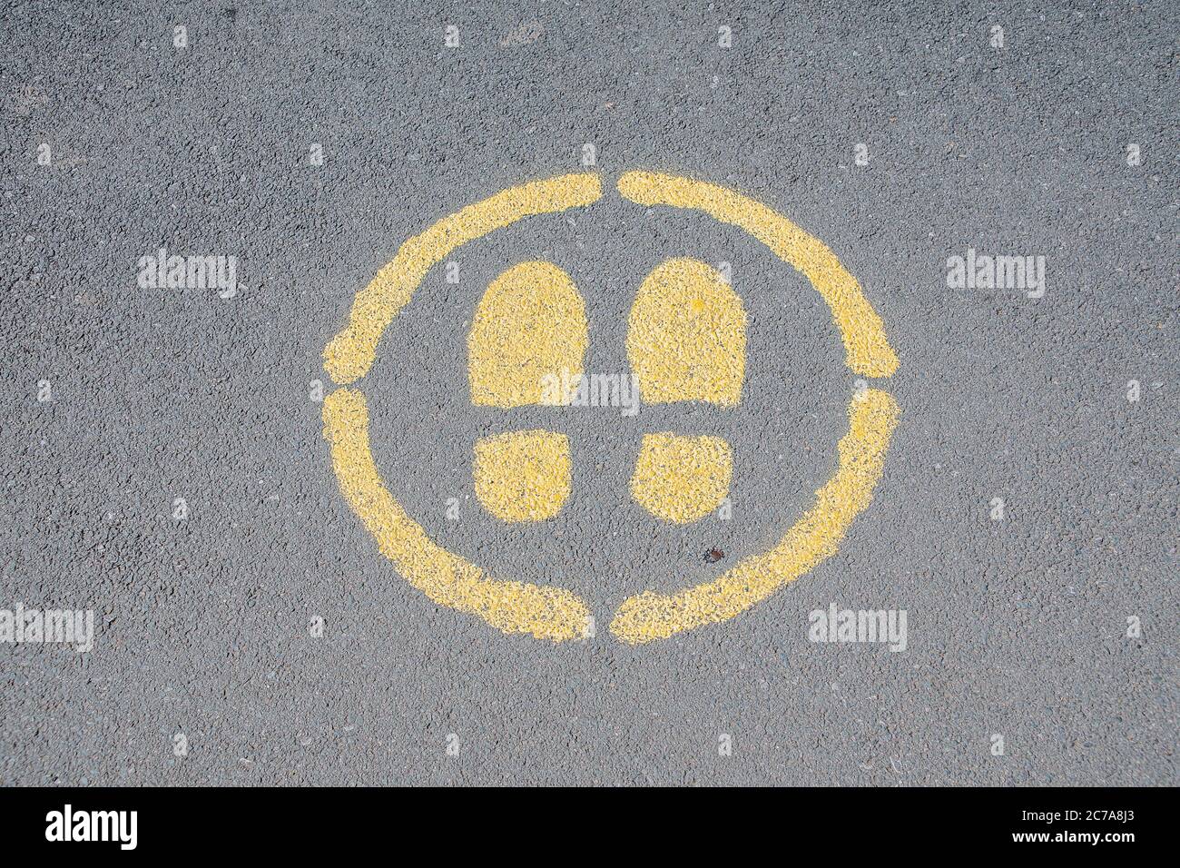 Sign painted on a pavement indicating where to stand Stock Photo - Alamy