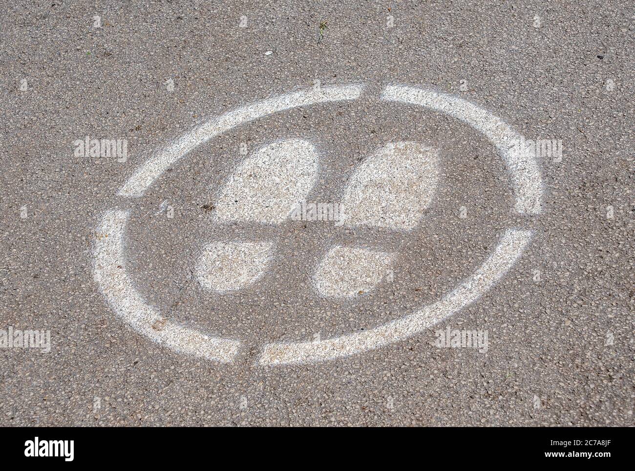Sign painted on a pavement indicating where to stand Stock Photo - Alamy