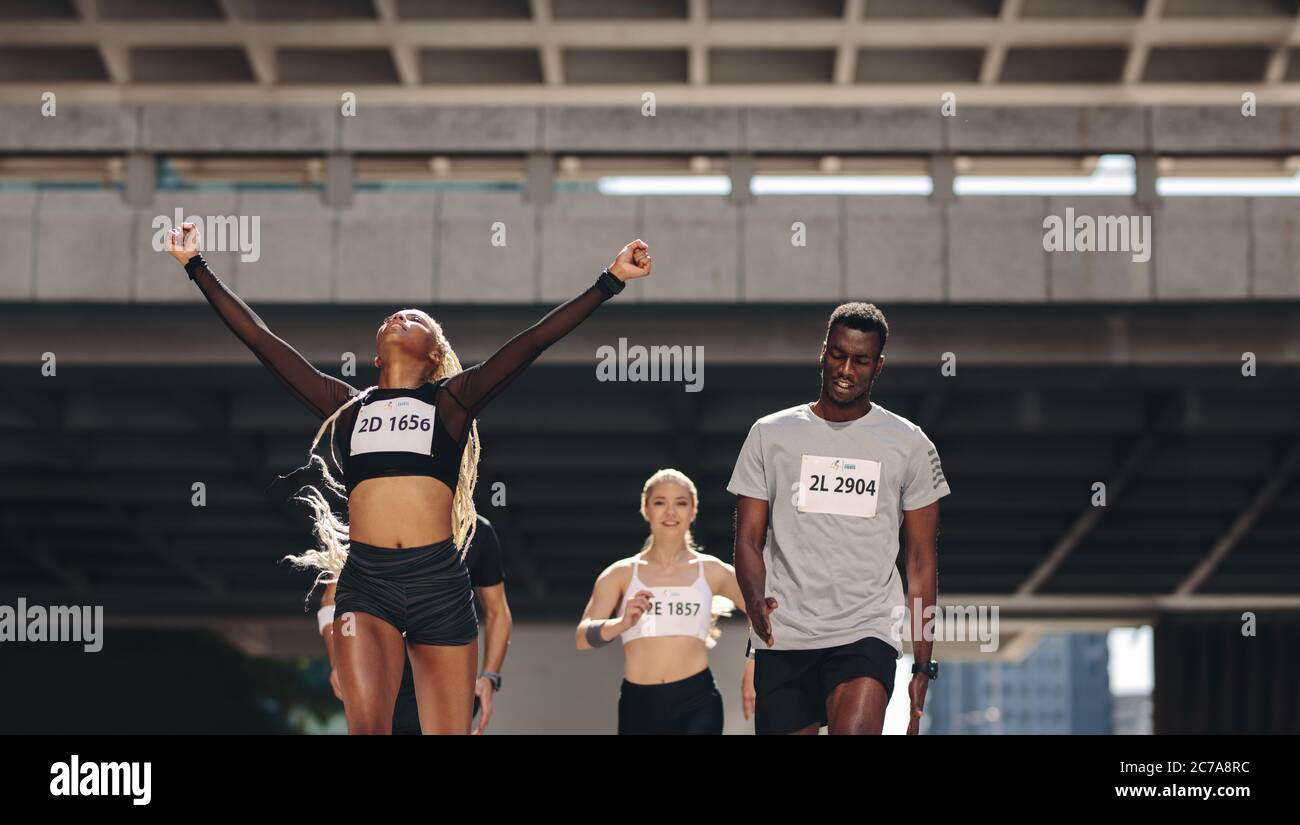 Female athlete crossing finish line hi-res stock photography and images ...