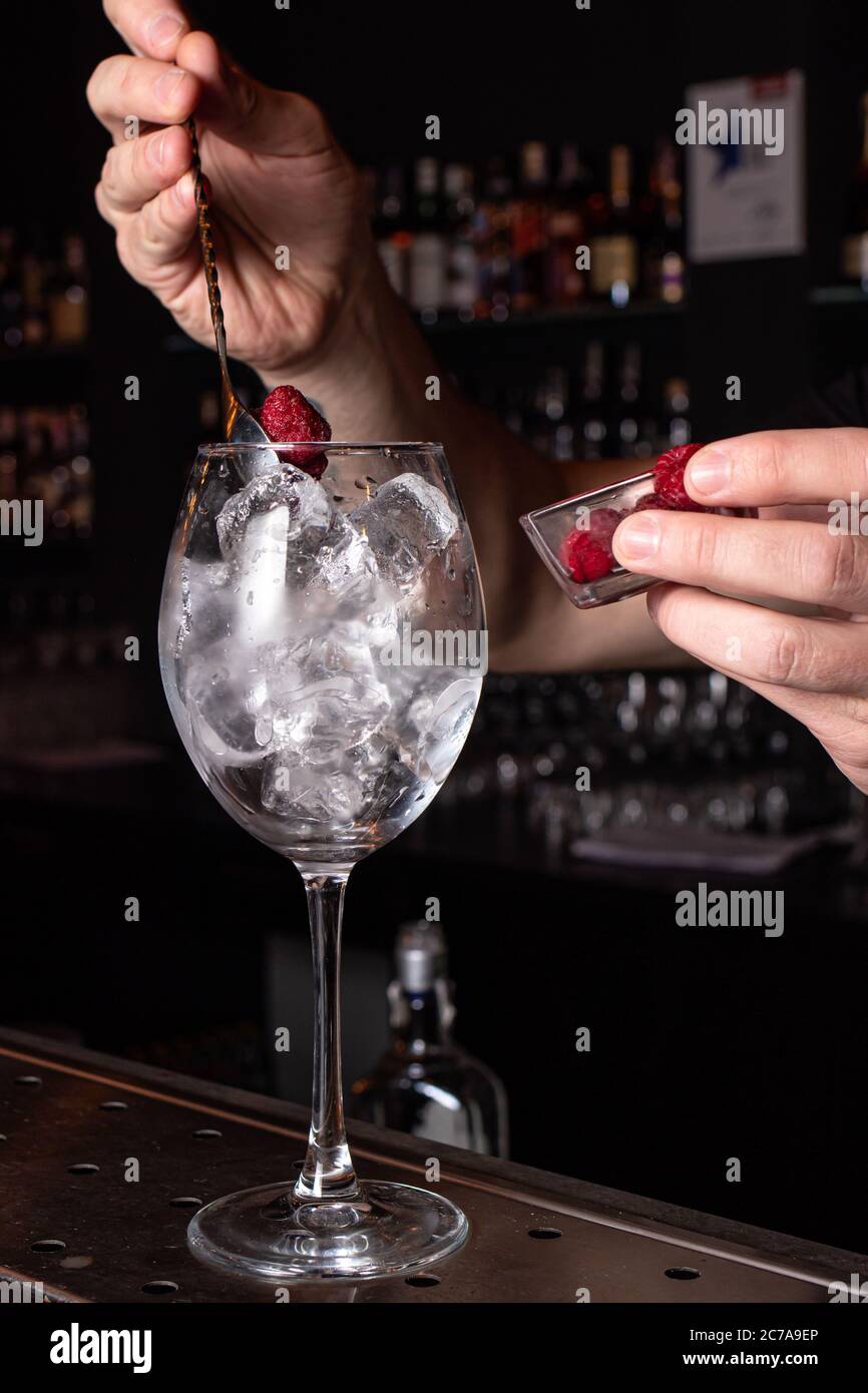 The bartender prepares a cocktail in the restaurant bar. The process of ...