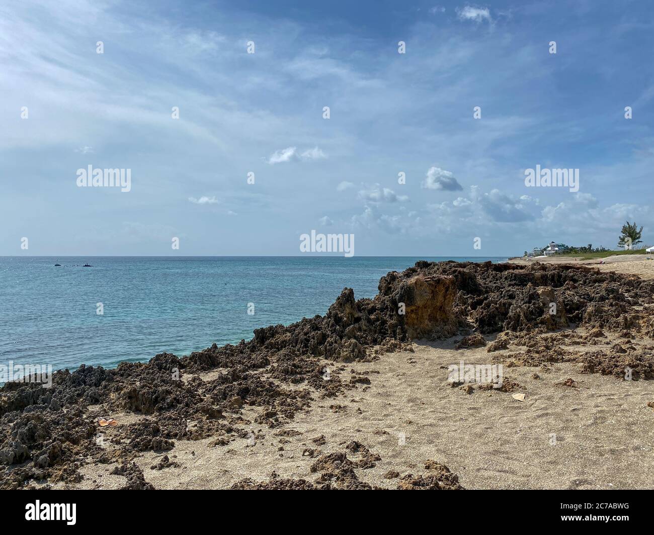 A rocky beach with clear turquoise water in Stuart, FL on a sunny day ...