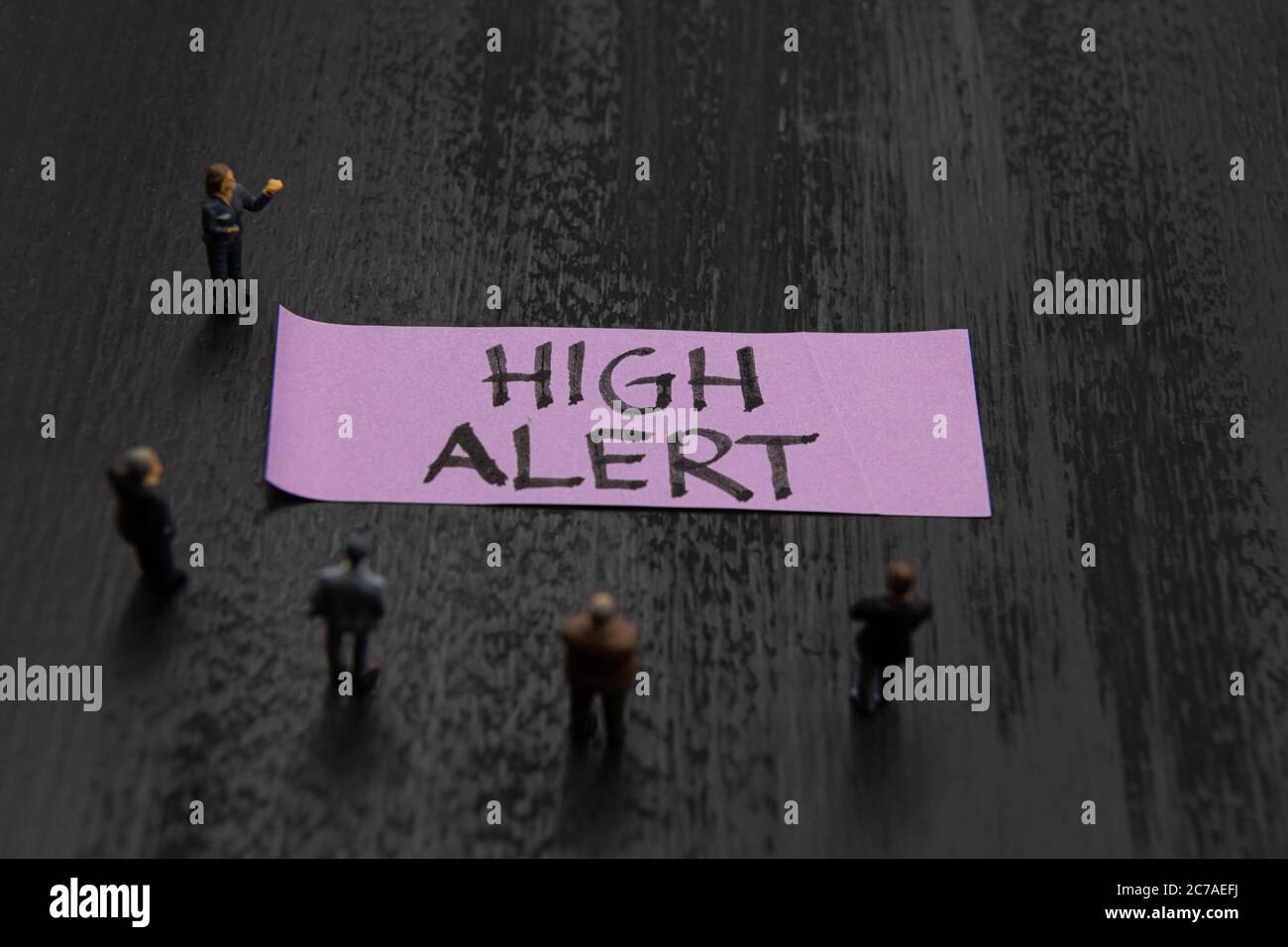 Strategy meeting with miniature figurines posed as business people ...