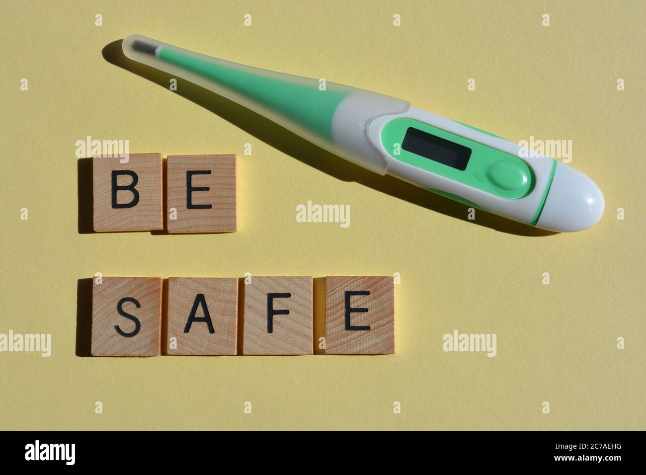 Be Safe, words in wooden alphabet letters and a digital thermometer ...