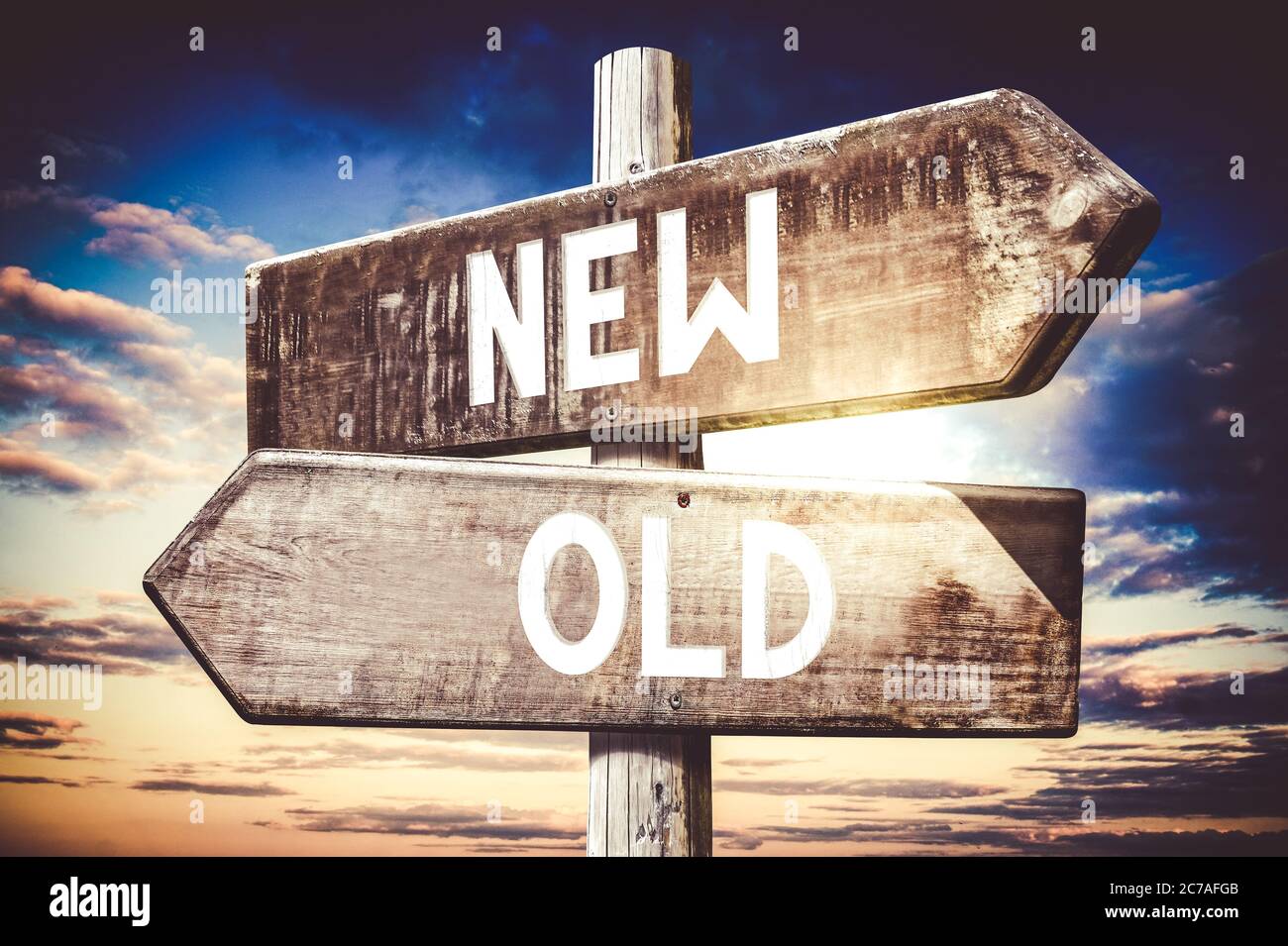New, old - wooden signpost, roadsign with two arrows Stock Photo - Alamy