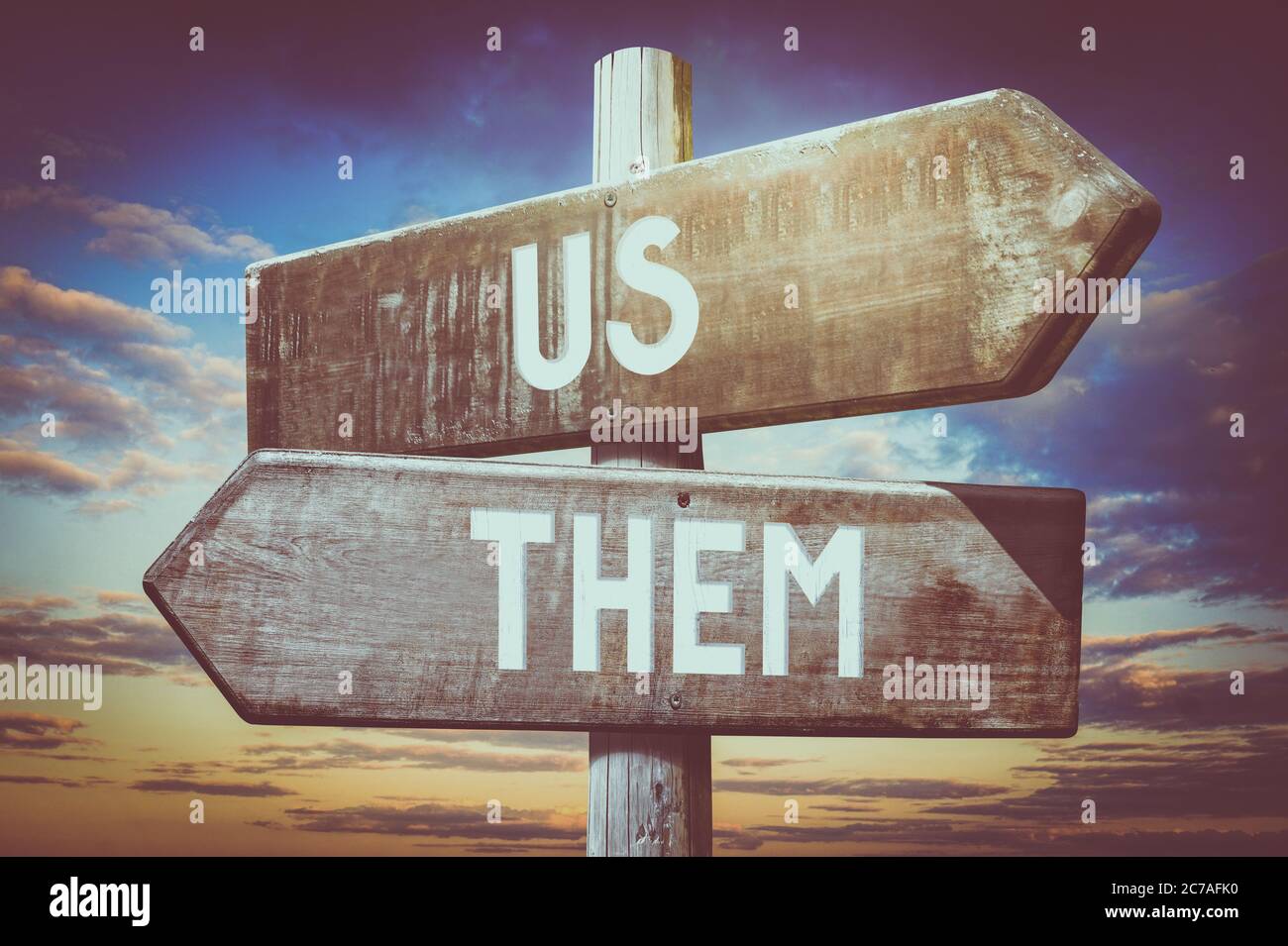 Us, them - wooden signpost, roadsign with two arrows Stock Photo - Alamy