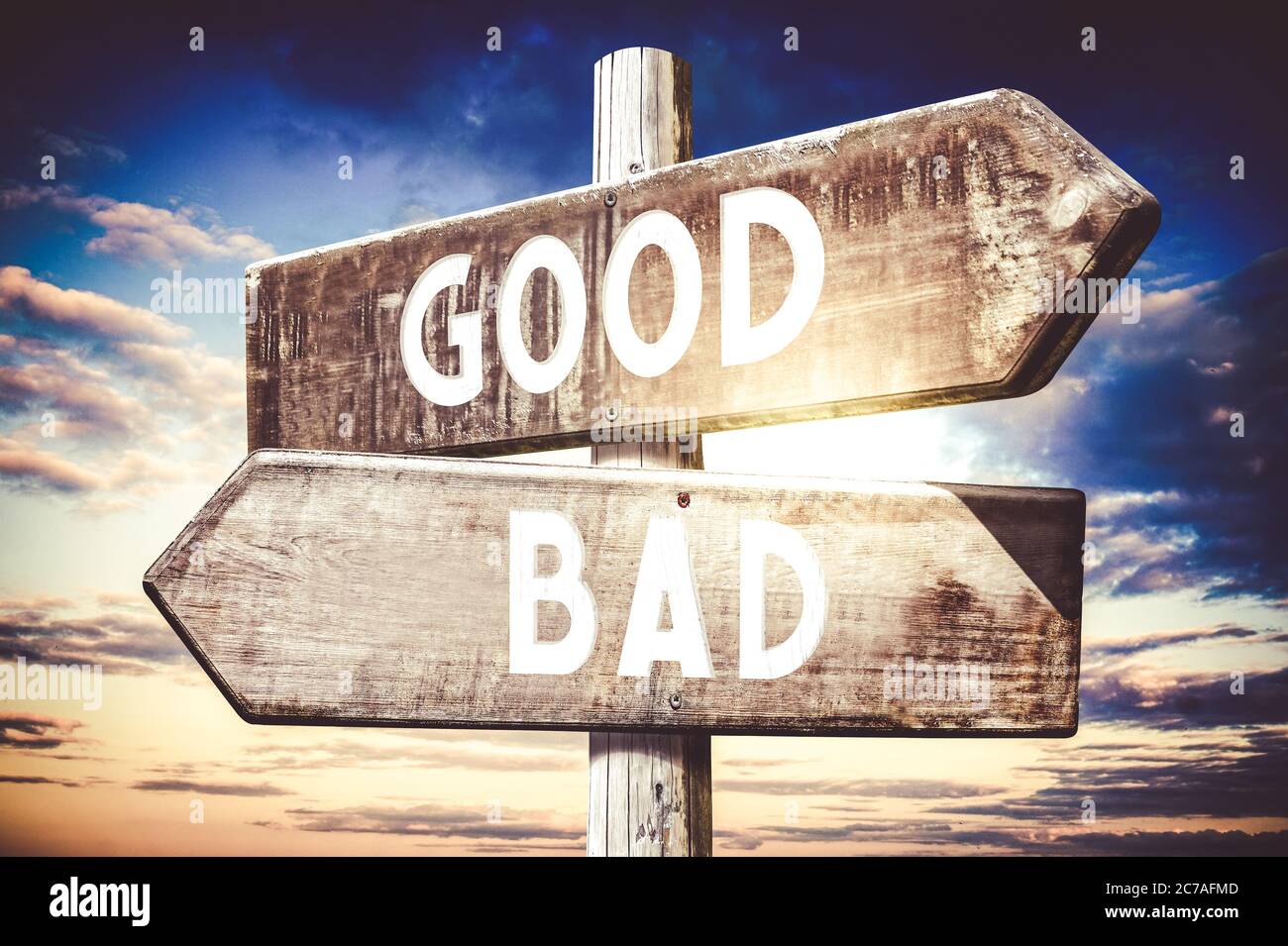 Good, bad - wooden signpost, roadsign with two arrows Stock Photo - Alamy